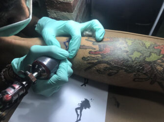 Girls that Scuba show their scuba related tattoos