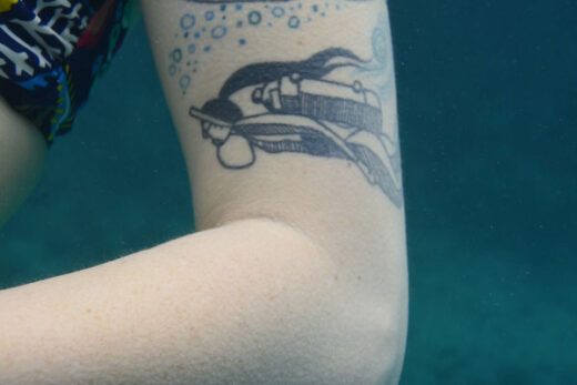 Girls that Scuba show their scuba related tattoos